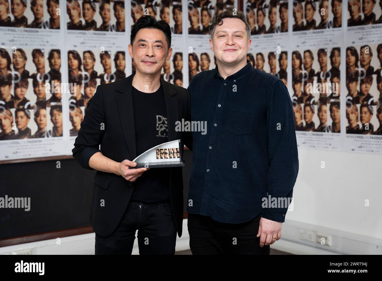 Kevin Chow of Orientouch Entertainment, left, receives a "Debut ...