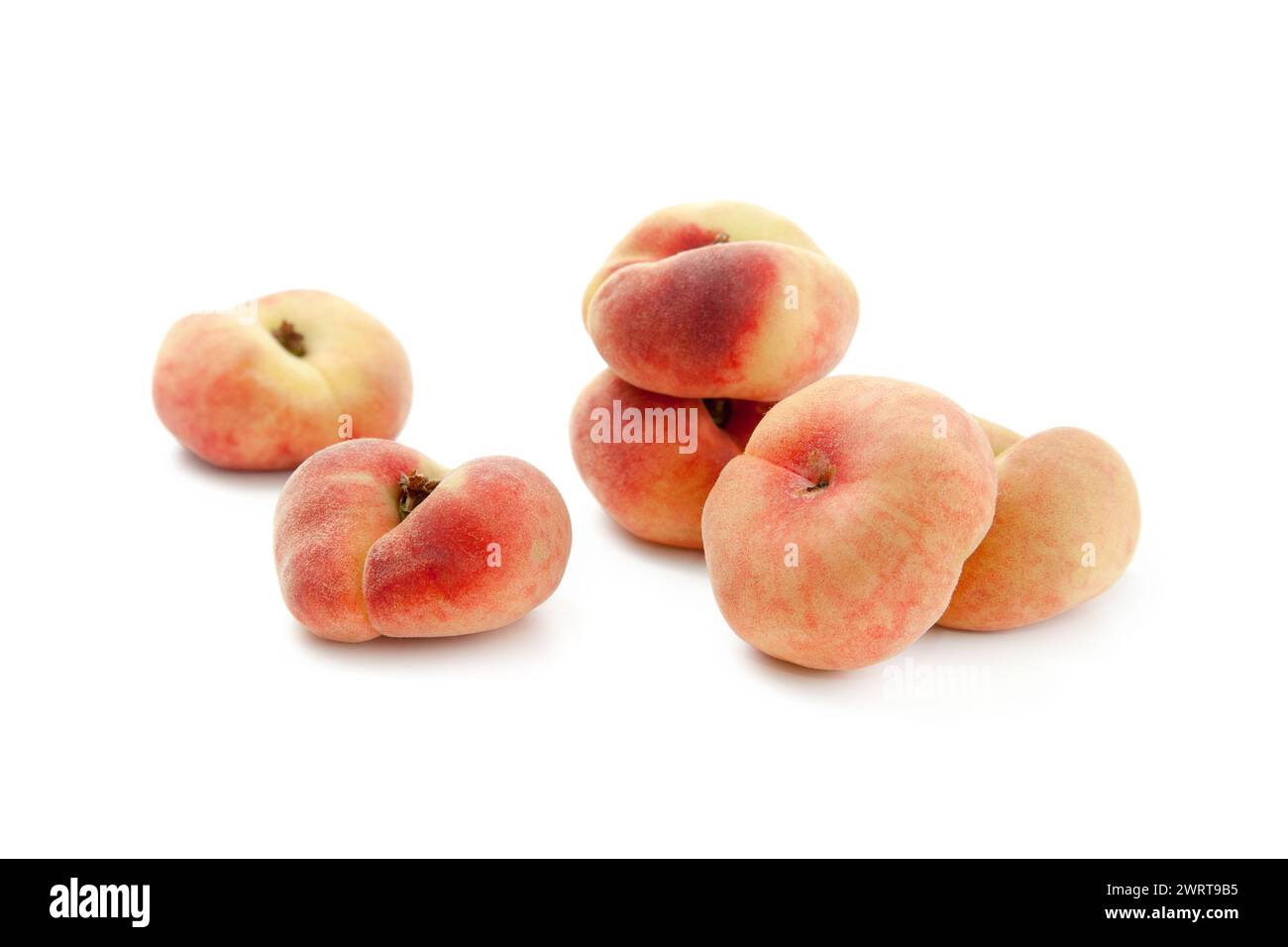 Several ripe chinese flat peach fruits or saturn peaches with soft ...