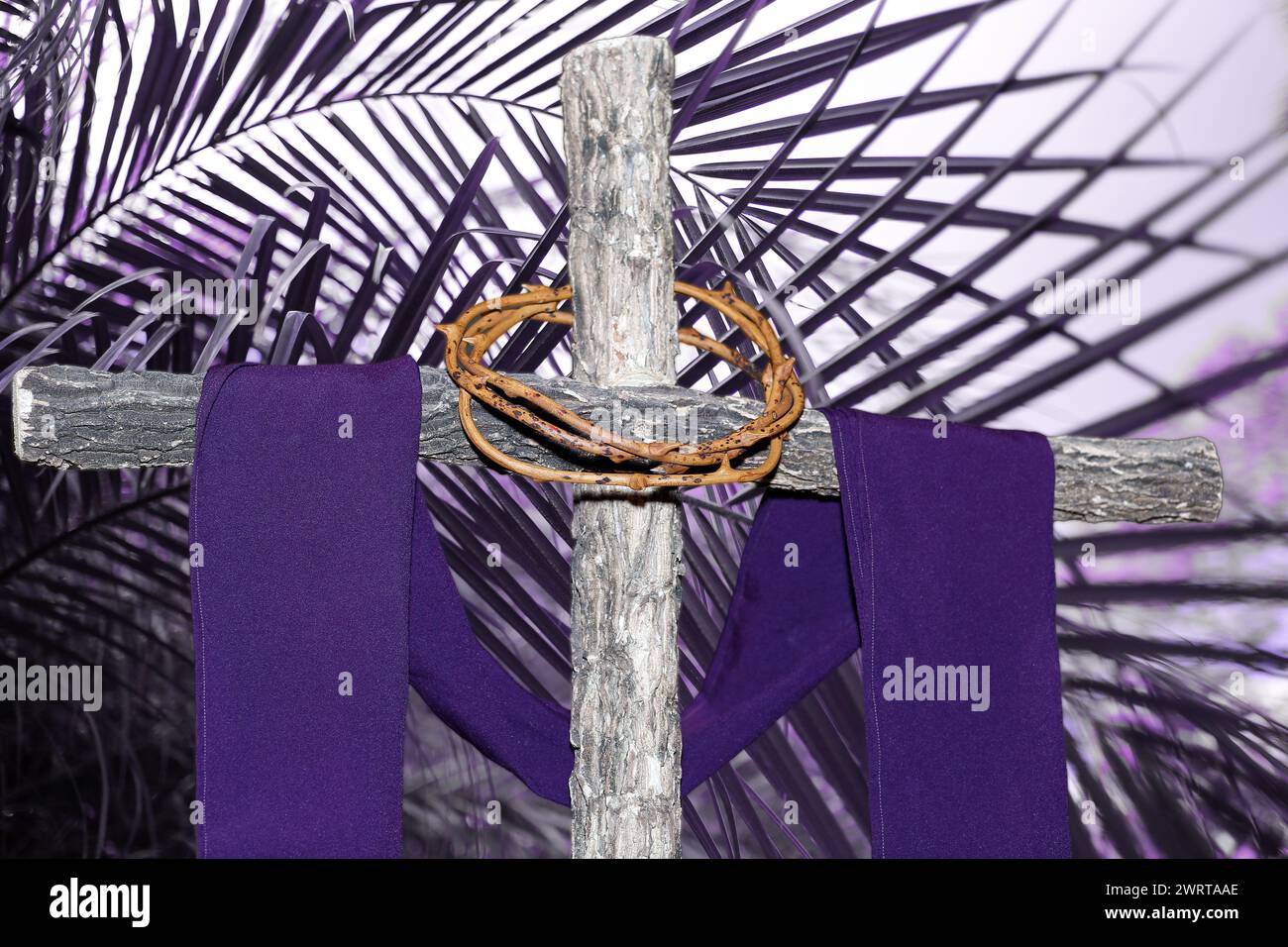 wooden cross with crown of thorns and purple fabric, catholic symbols ...