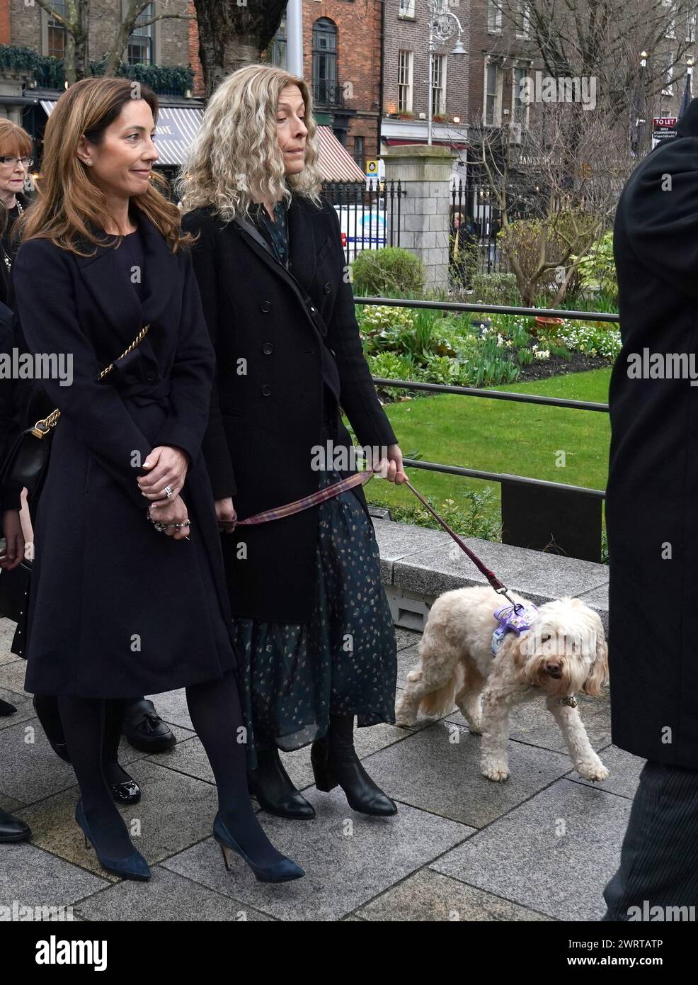 Charlie Bird's wife Claire with his dog Tiger follow his coffin as it ...