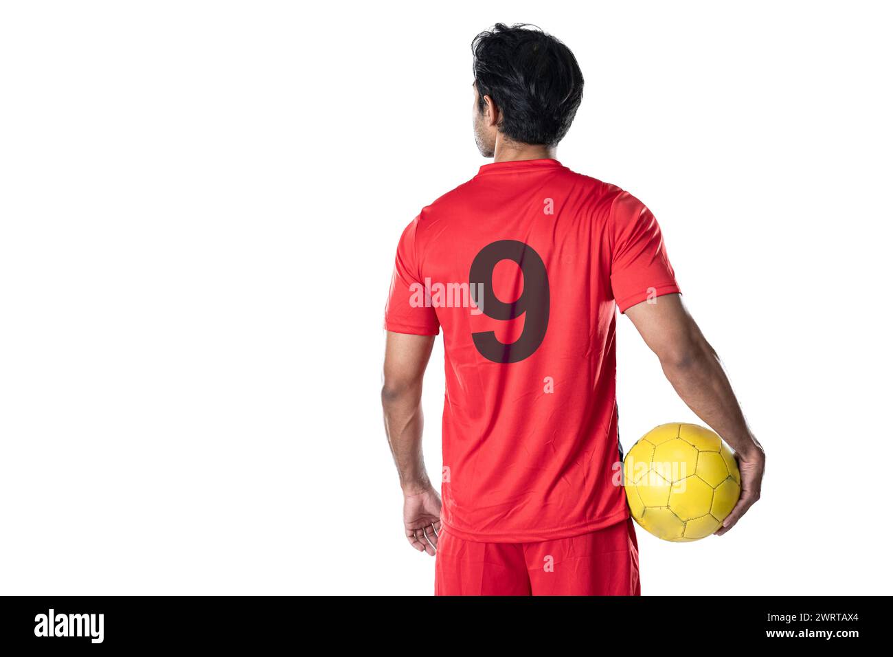 professional football player in red training uniform pose on a white ...