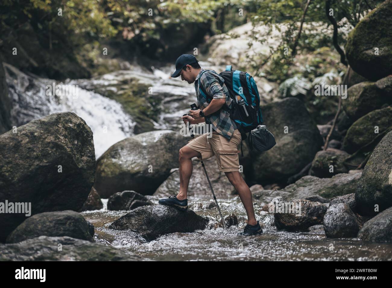 Hikers use trekking pole with backpacks walking through the rock and ...