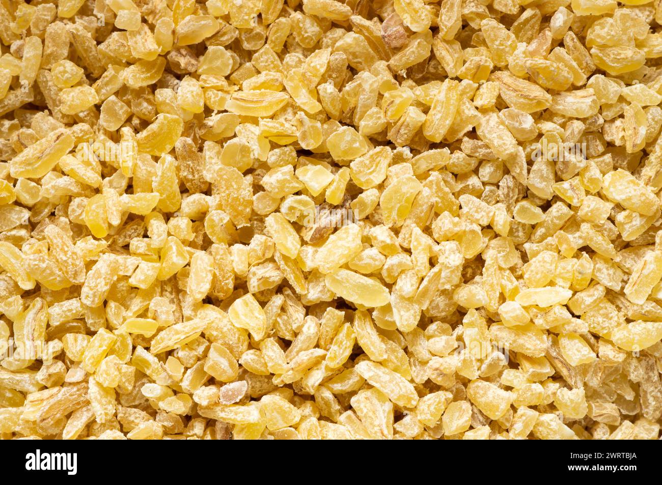 Dry bulgur wheat grains textured background. Heap of uncooked bulghur ...