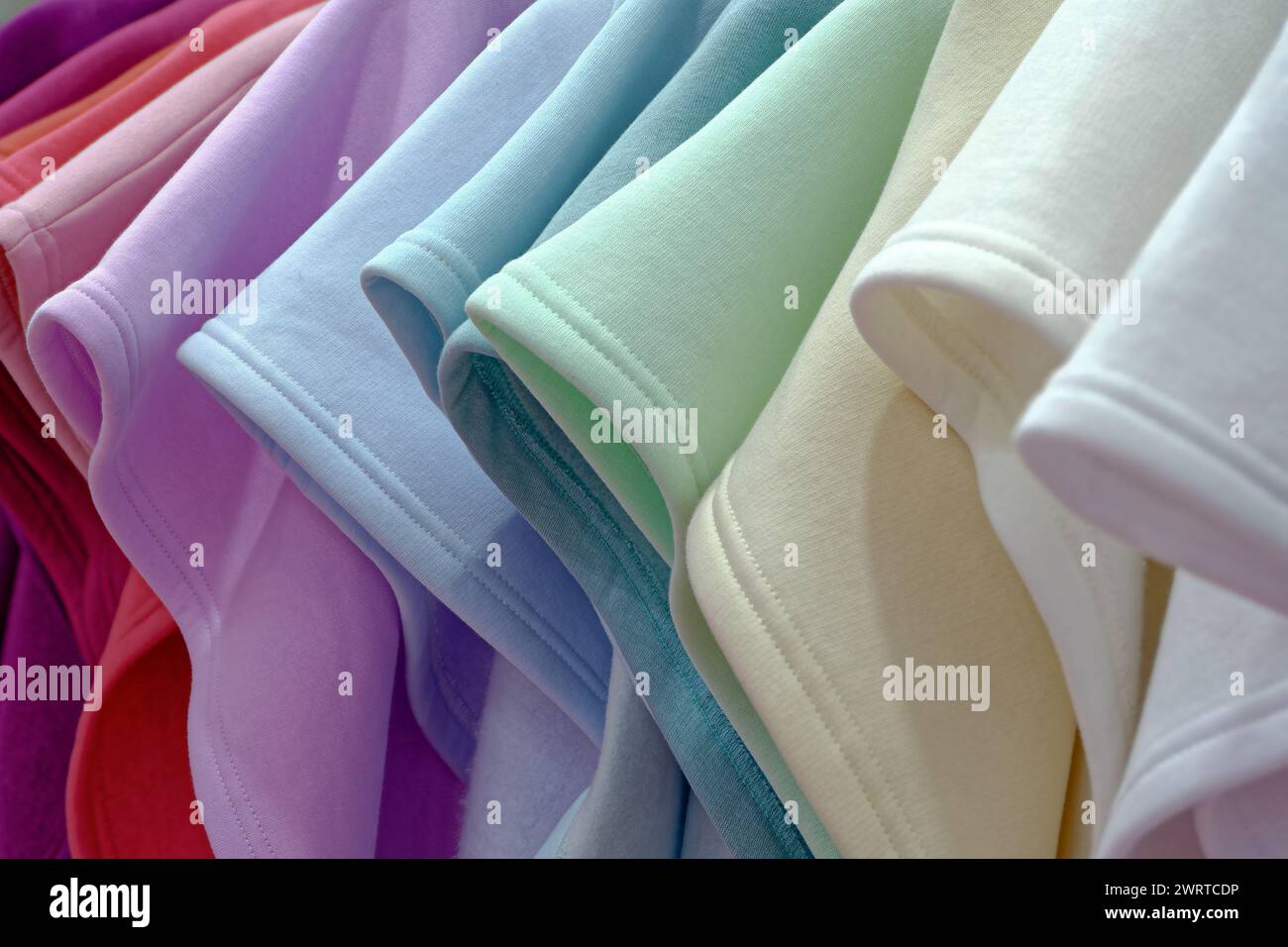 Group of multi-coloured knitted tricot clothing in pastel colours ...