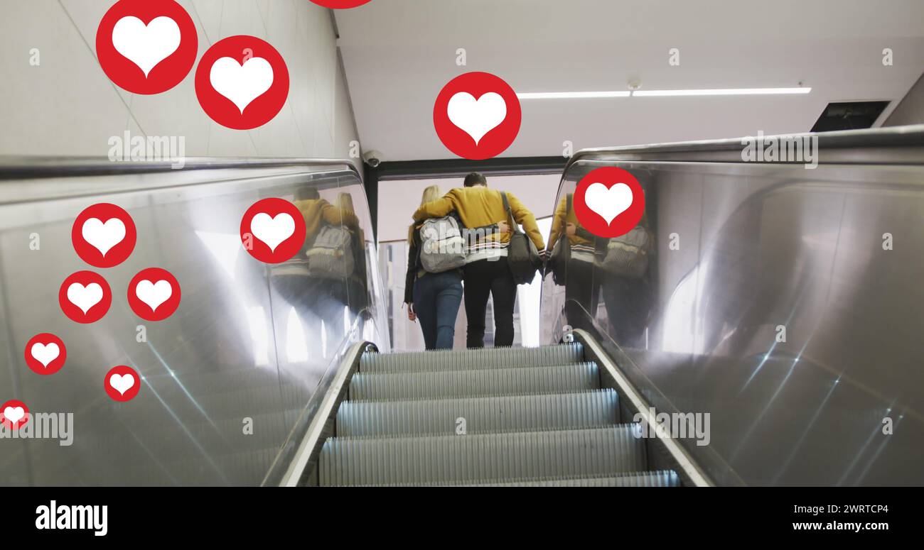 Image of heart icons floating over couple embracing on moving stairs ...