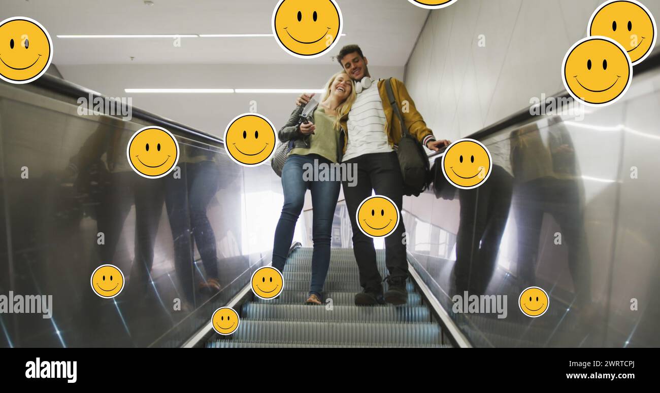 Image of digital emoji icons floating over happy caucasian couple ...