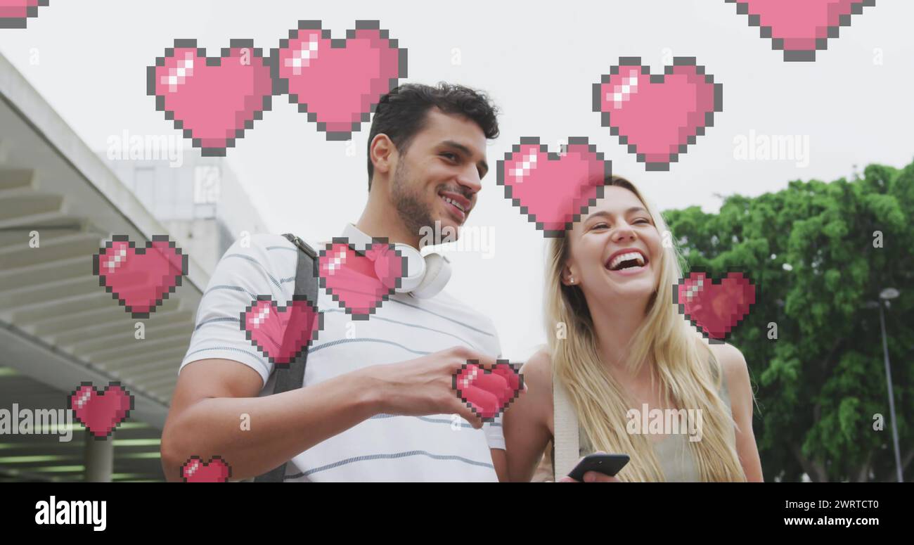 Image of heart icons floating over happy caucasian couple talking and ...