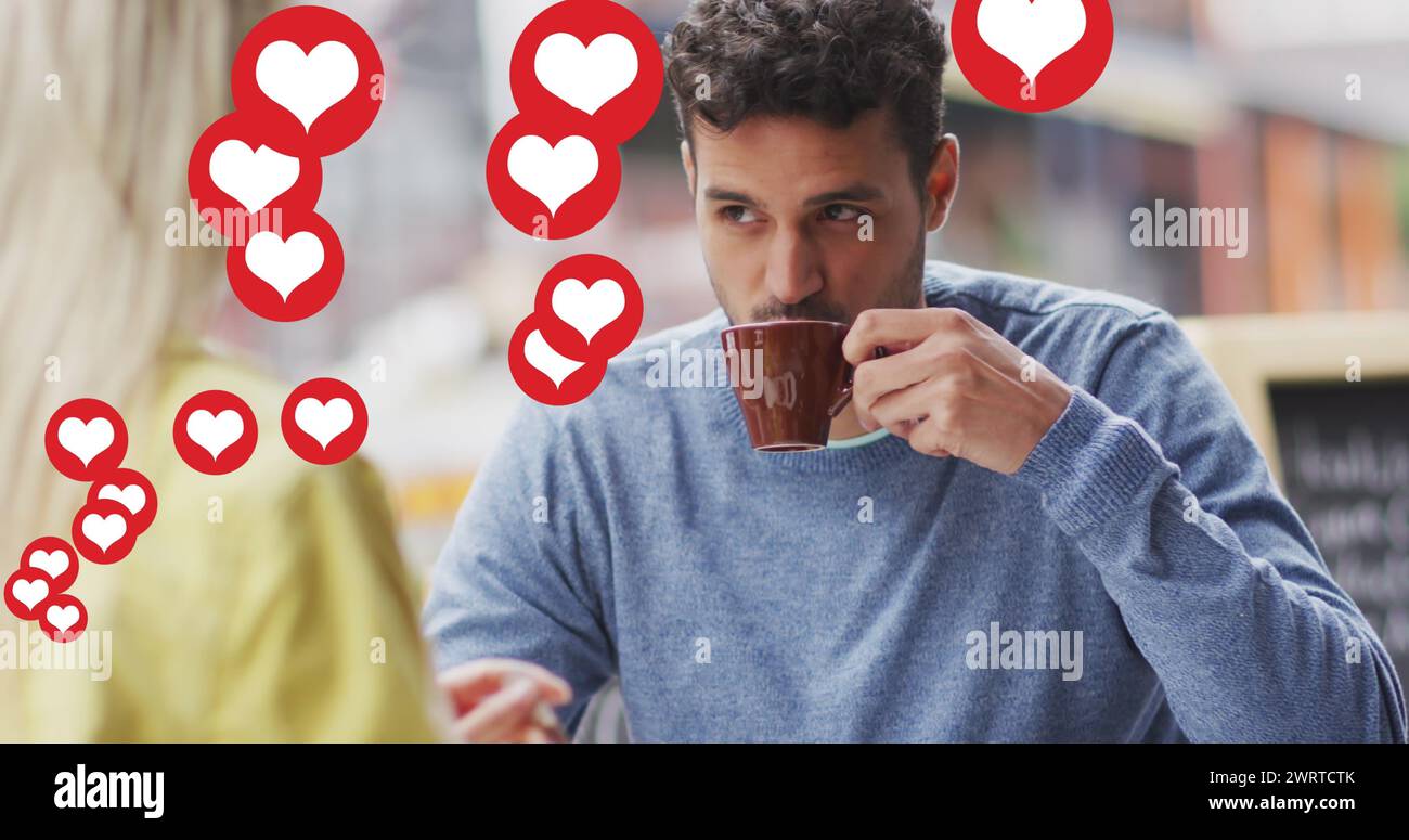 Image of heart icons floating over happy caucasian couple talking and ...