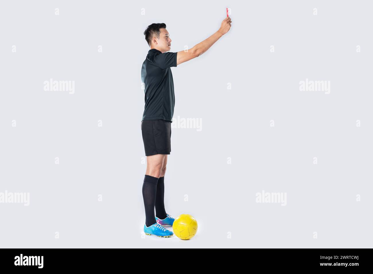 Full length portrait of a football referee giving a red card isolated ...