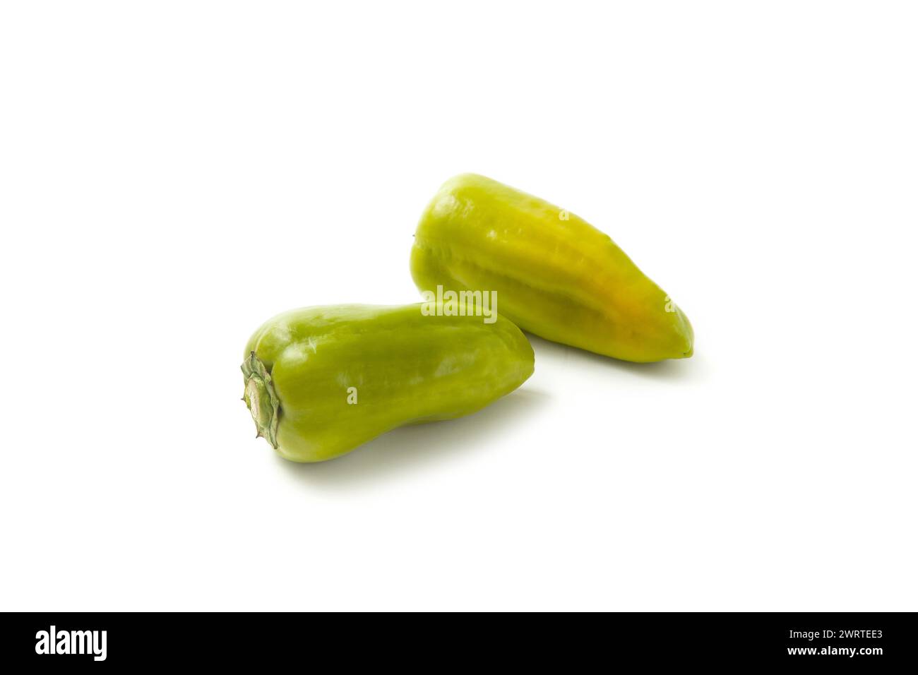 Two whole green bell pepper (capsicum) known as sweet bell pepper ...