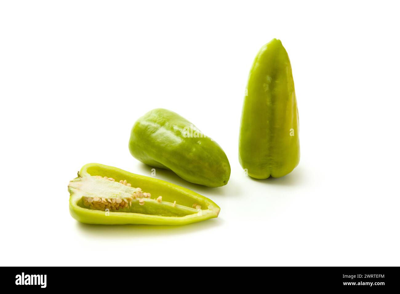 Two whole and half of green bell pepper (capsicum) known as sweet bell ...