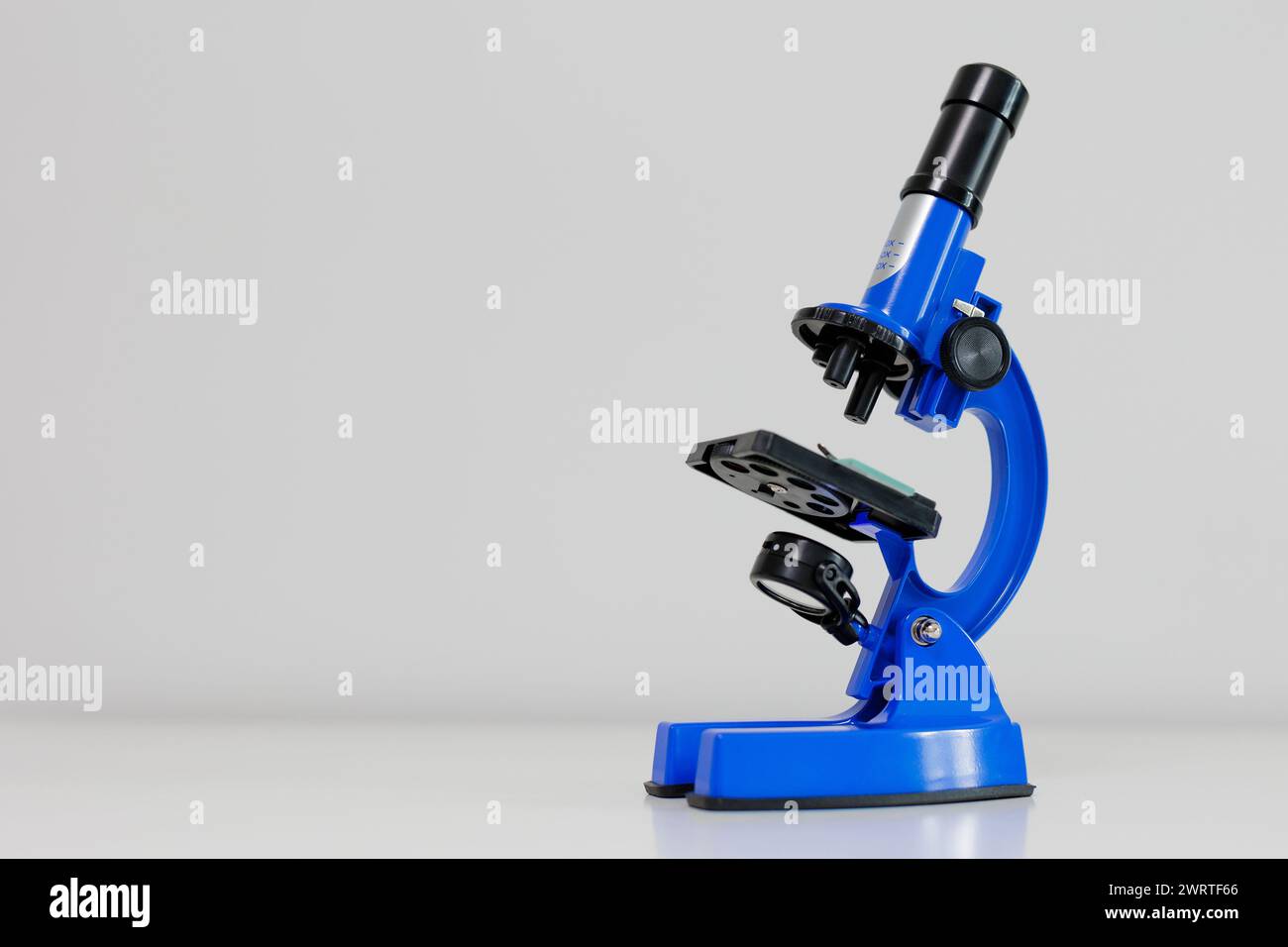 Blue metal microscope standing on table with copyspace Stock Photo - Alamy