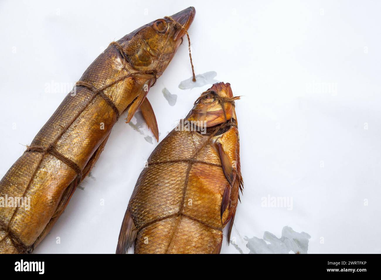 Appetizing smoked freshwater pike and common bream fish in smokehouse ...