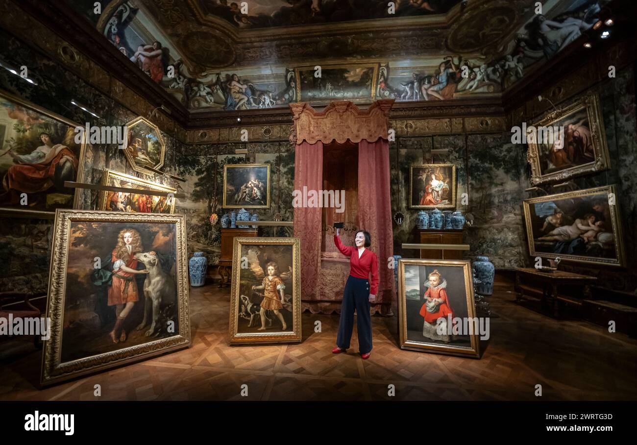 Curator Gill Hart pretends to take a photograph during a photocall as ...