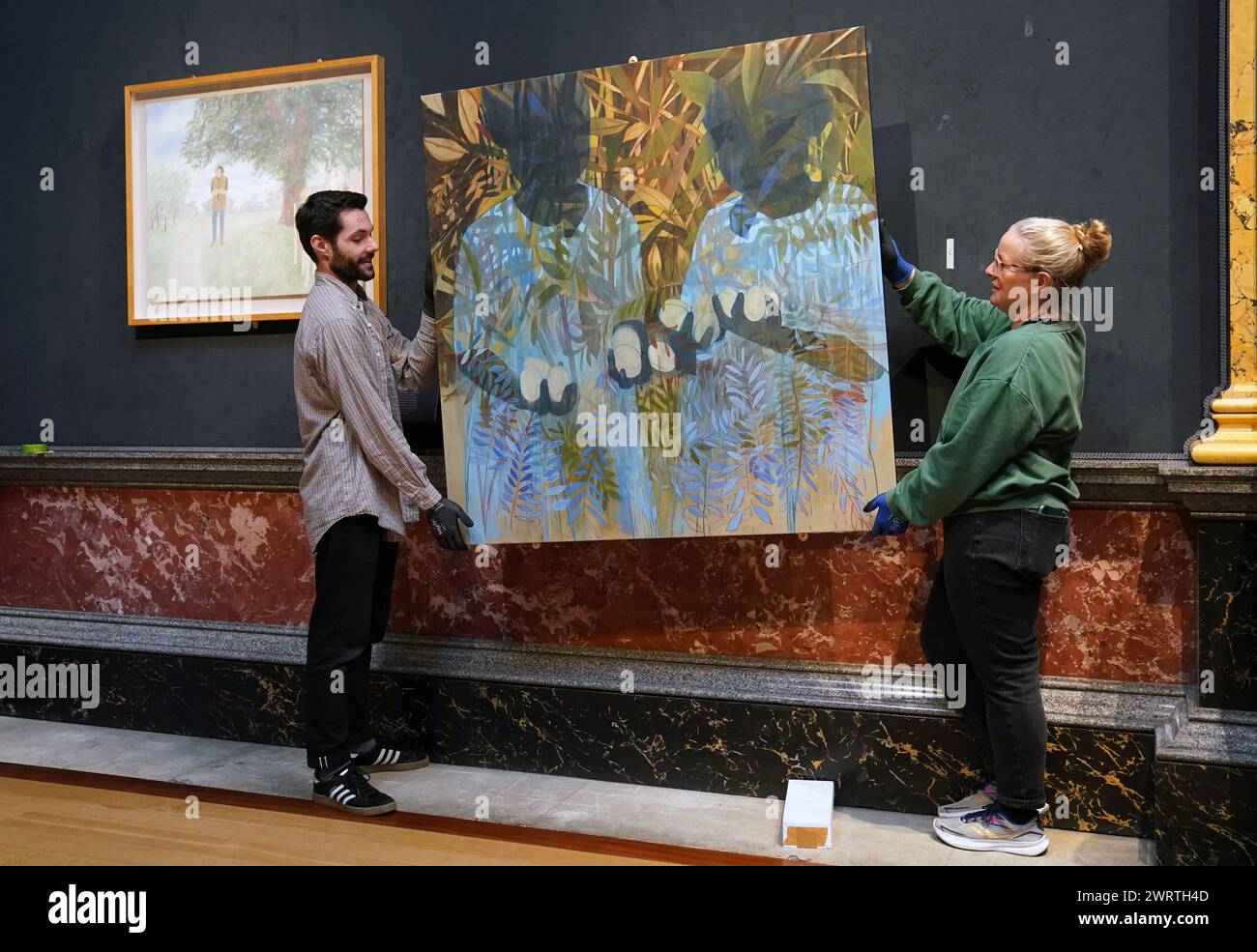 Gallery technicians hang 'The Dream II (mae) by Pamela Phatismo ...