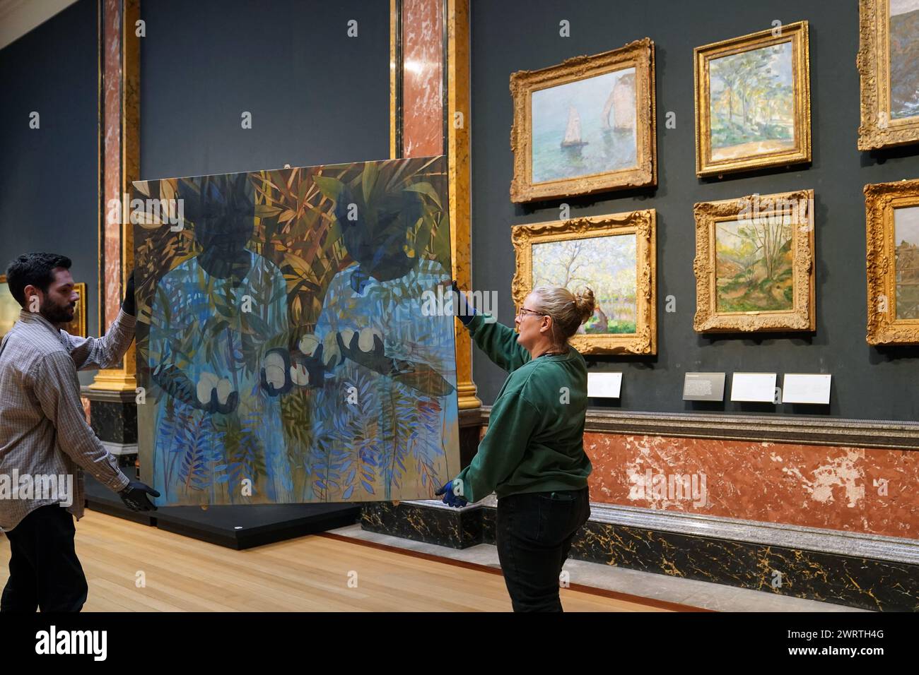 Gallery technicians hang 'The Dream II (mae) by Pamela Phatismo ...