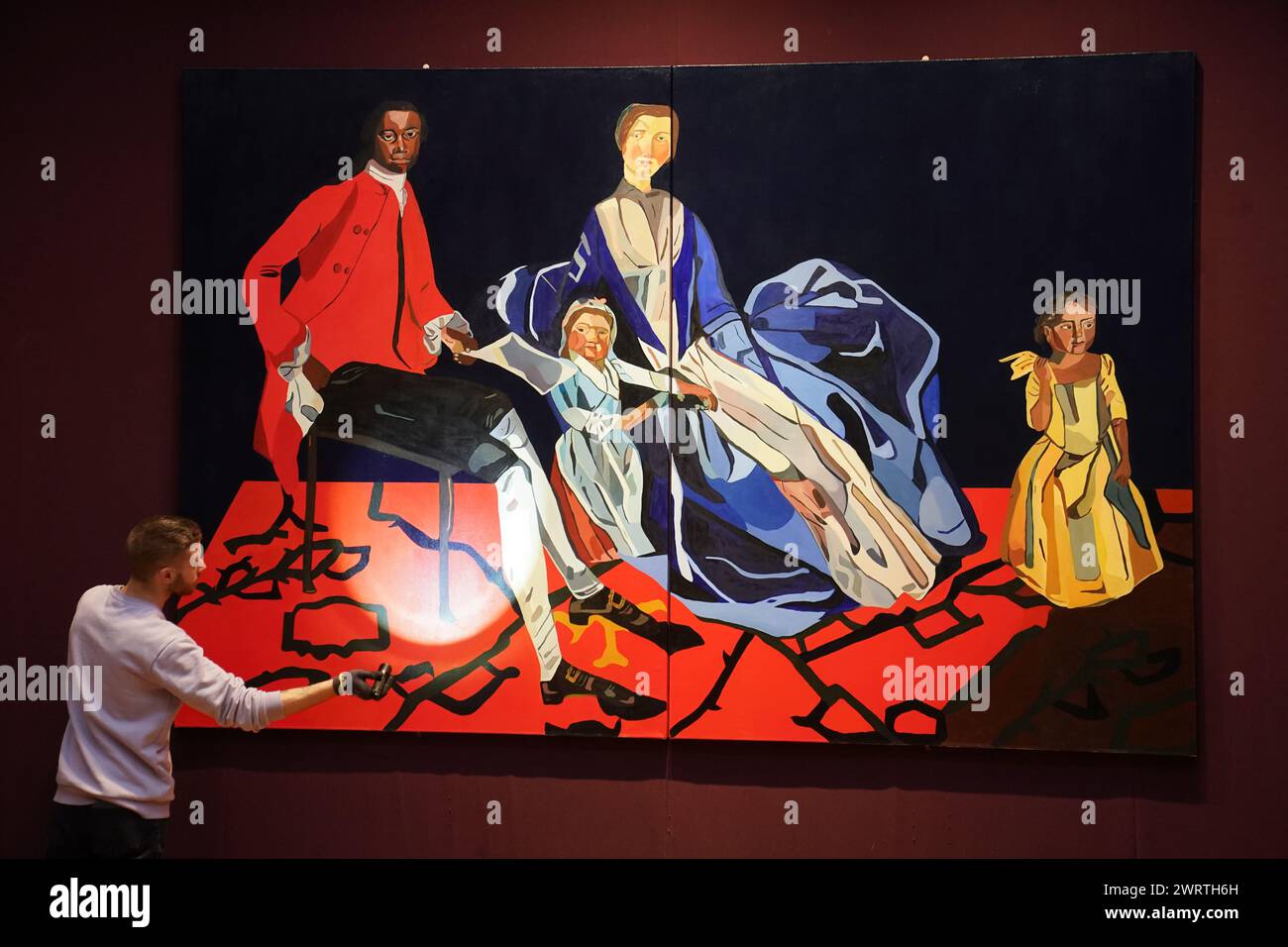 Gallery technician Niall Fall inspects 'An 18th-Century Family' by Joy ...