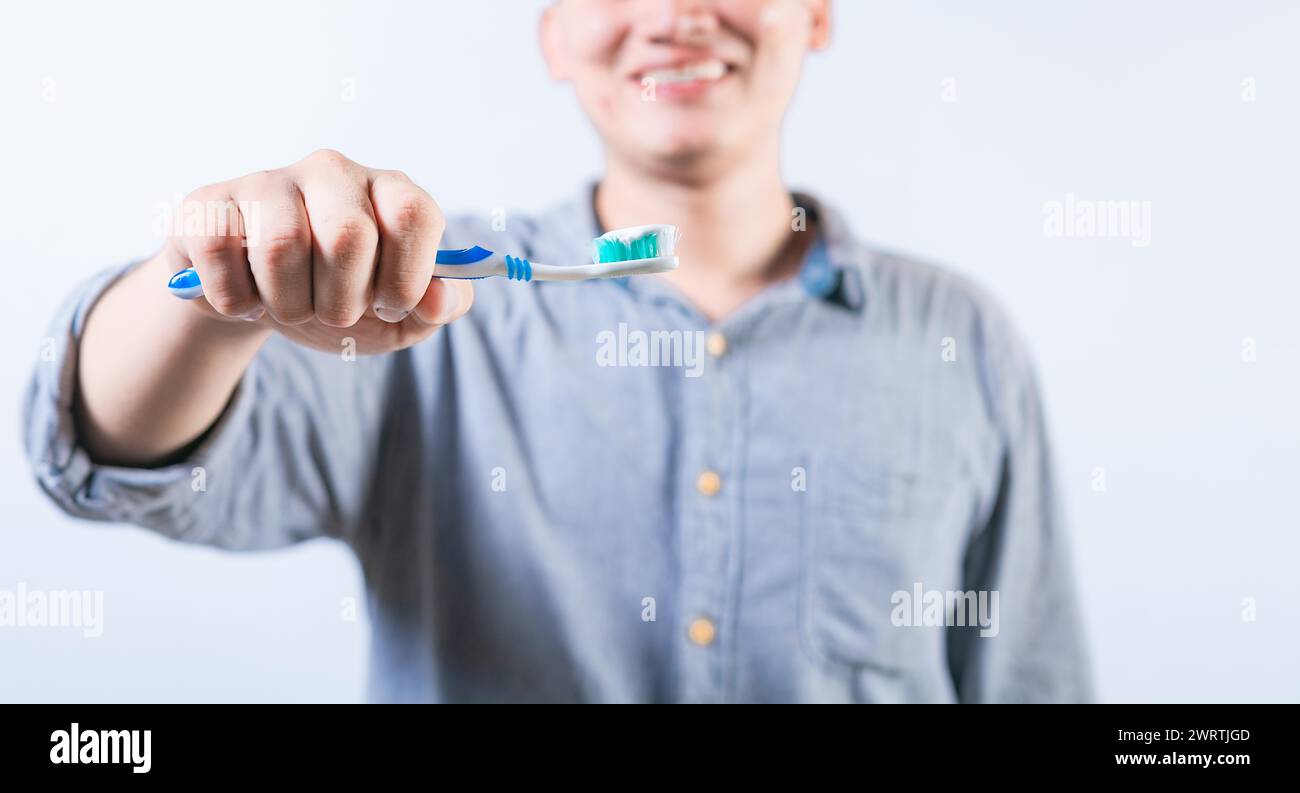 Smiling person showing toothbrush with toothpaste isolated ...