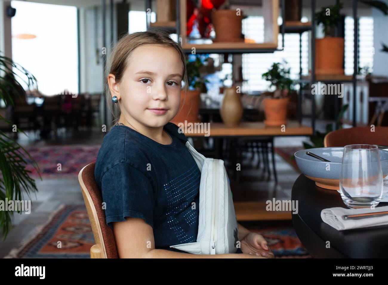 Cute girl enjoying dinner at the restaurant Stock Photo - Alamy