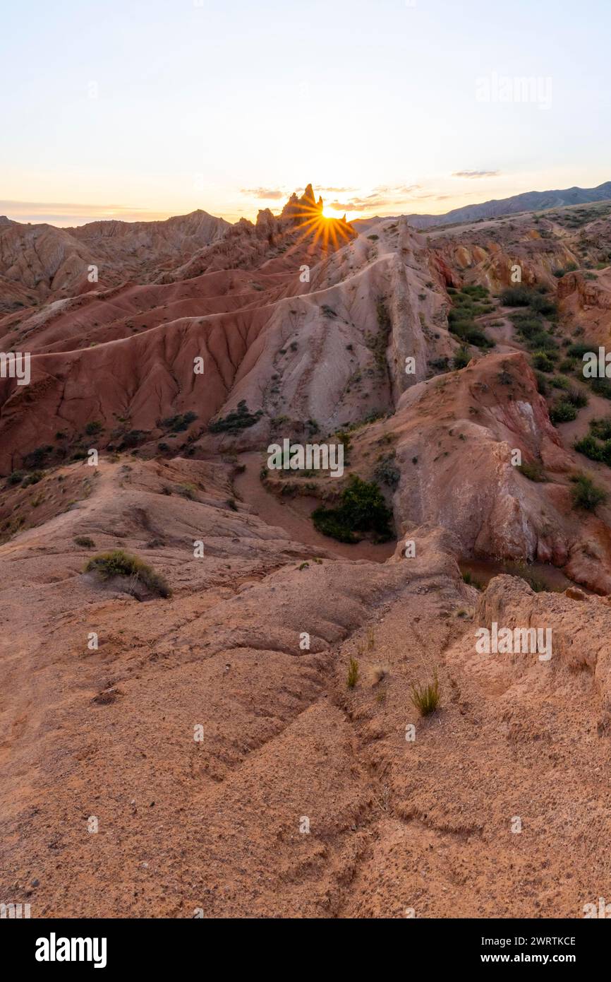 Erosion landscape of red sandstone, rock formations at sunrise with sun ...