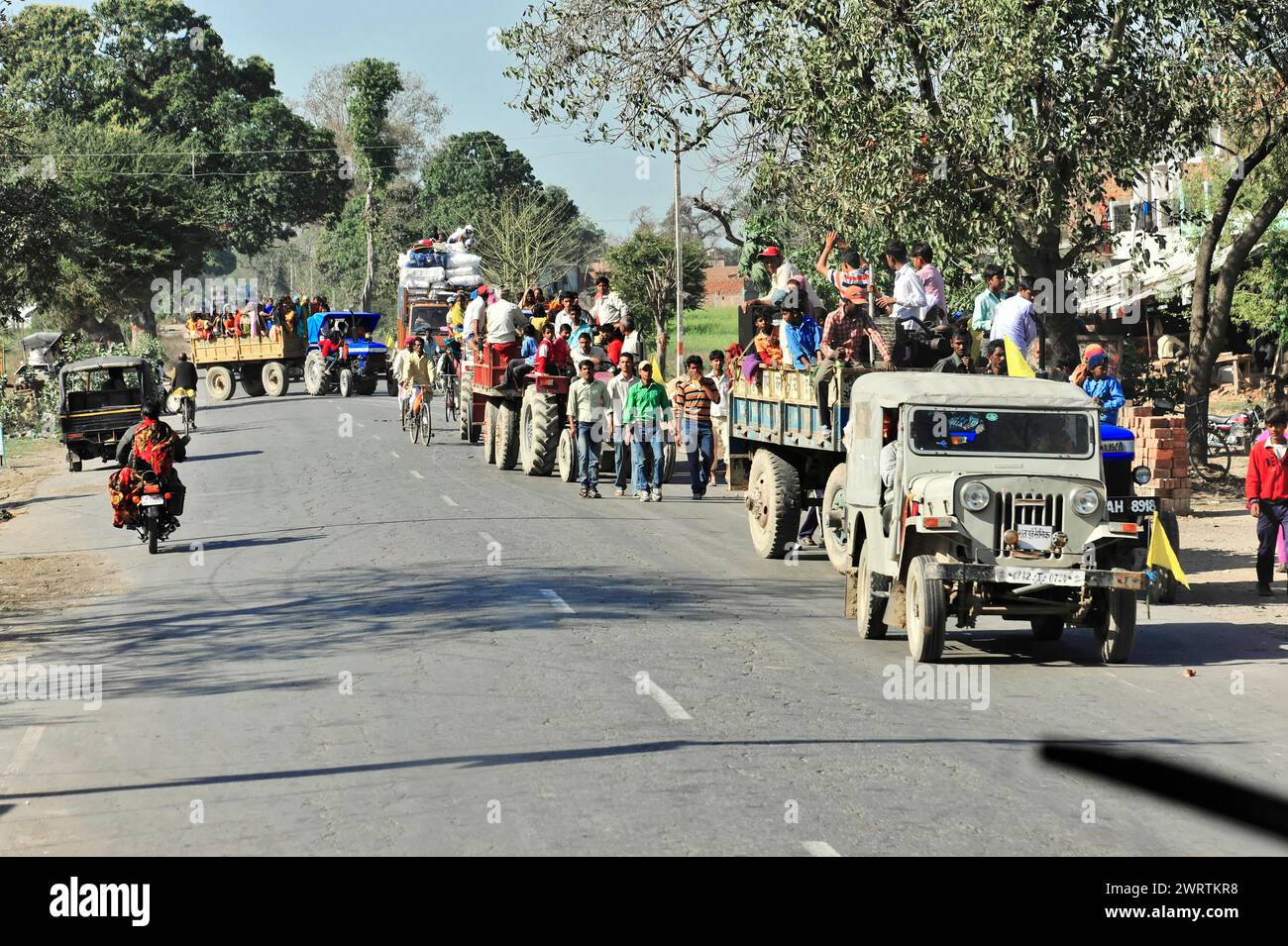 Busy street scene with traffic, people on motorbikes and in cars, India ...