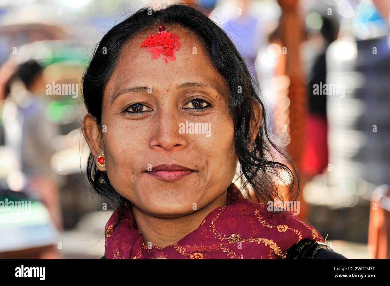 Portrait of a serious looking woman with a red bindi on her forehead ...