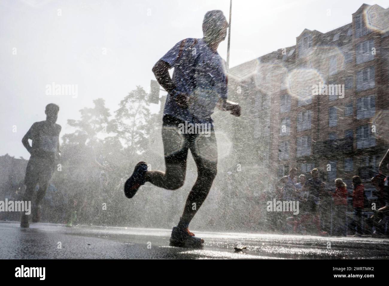 The participants of the Berlin Marathon are cooled down with a water ...