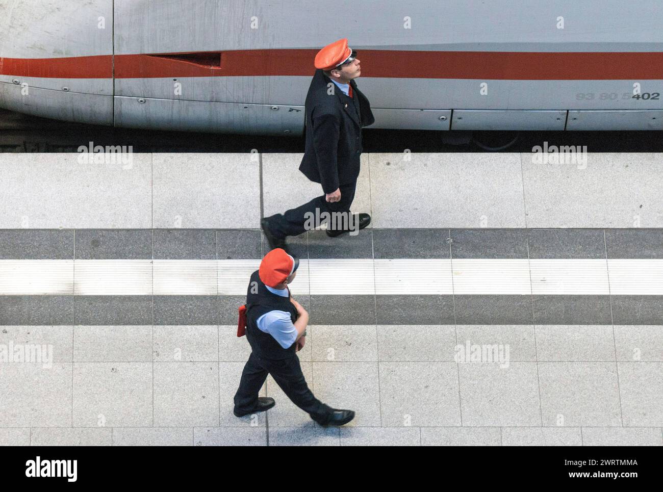 Deutsche Bahn service staff walk along an ICE train on the platform, 26 ...