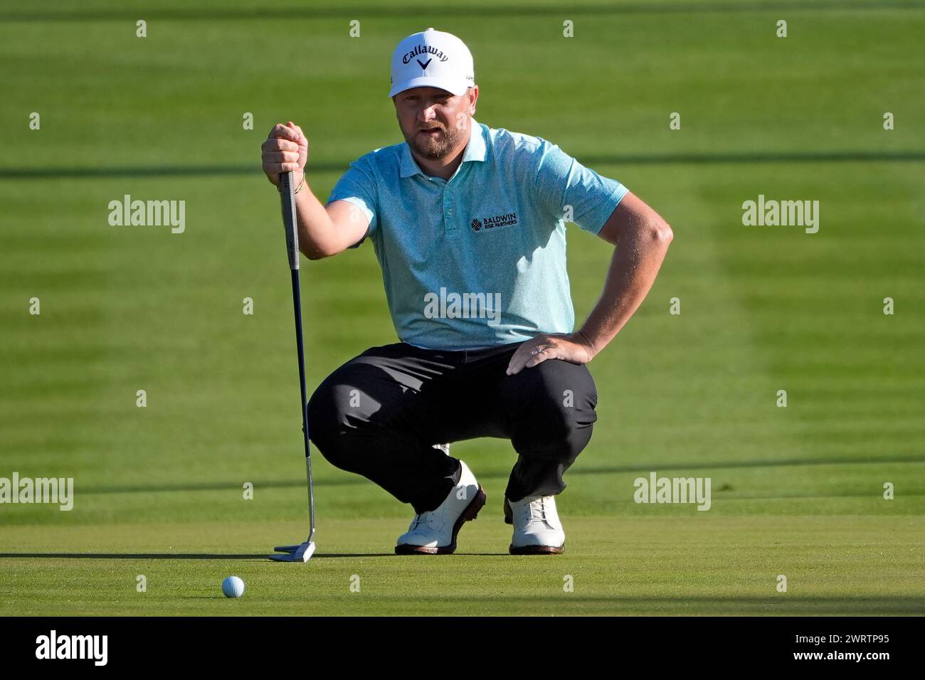 Brice Garnett checks his line on the second hole during the first round ...