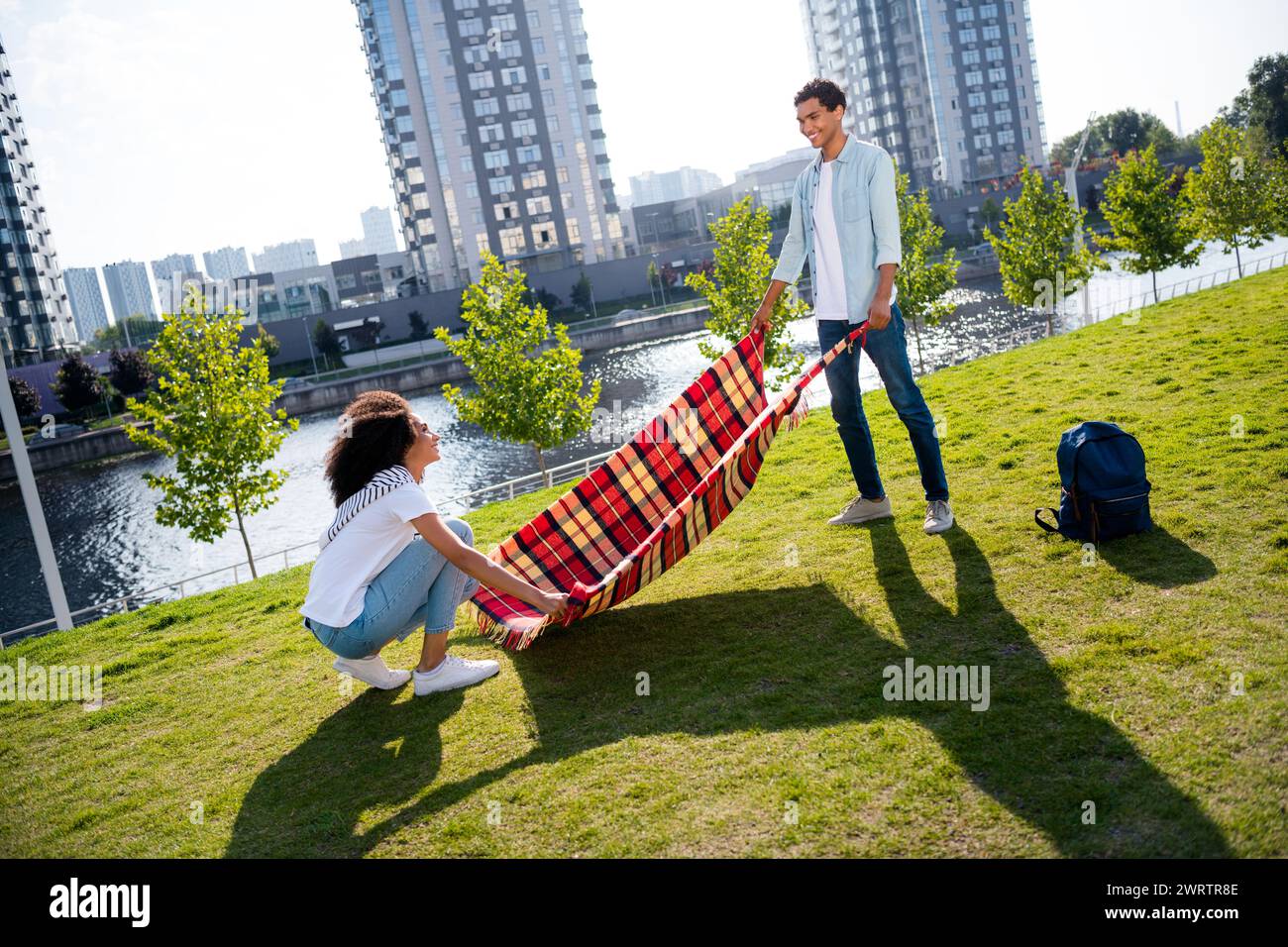 Full body photo of two idyllic positive partners lay picnic blanket ...