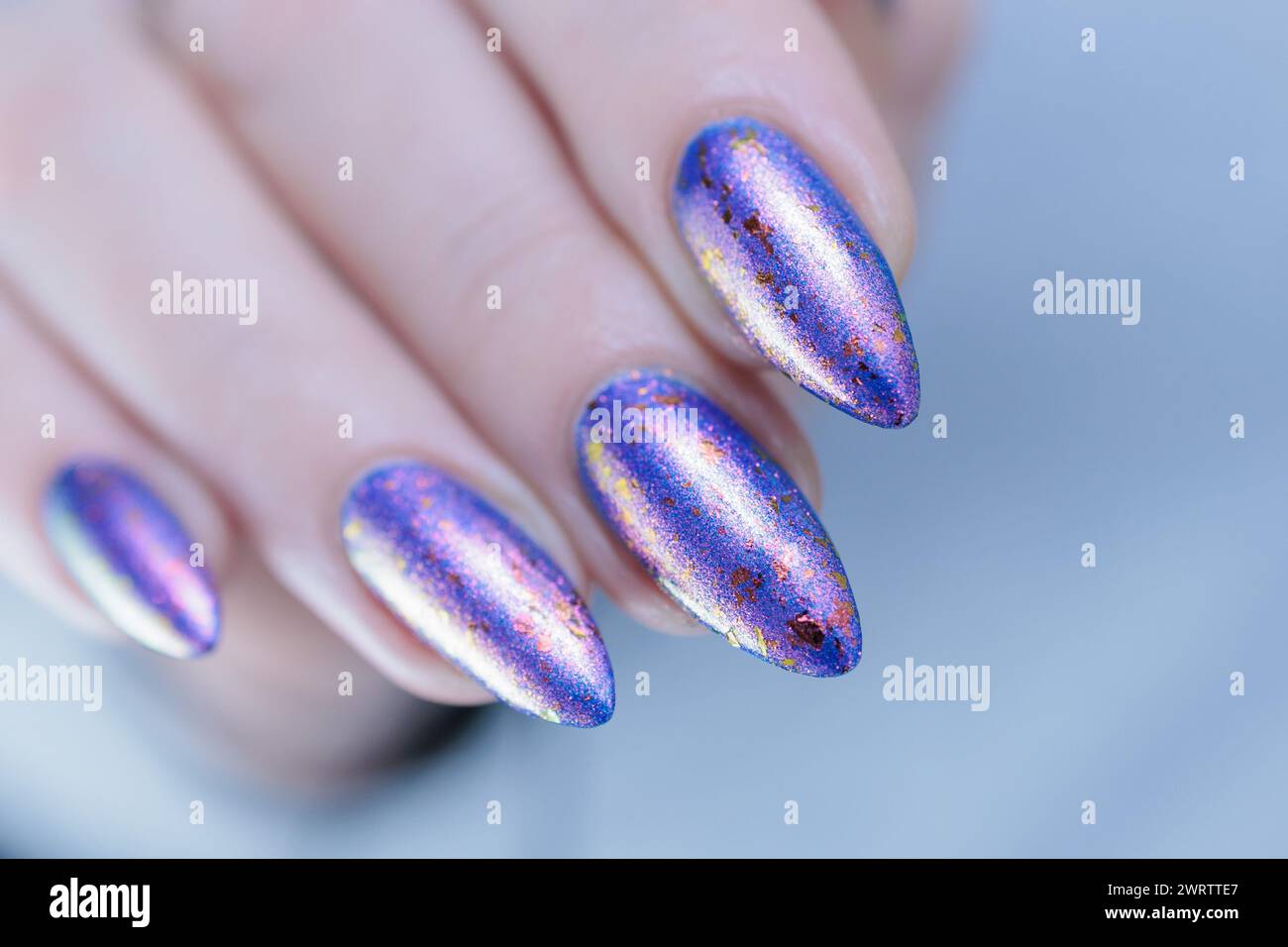 Female hand with long nails and a blue lilac color nail polish Stock ...