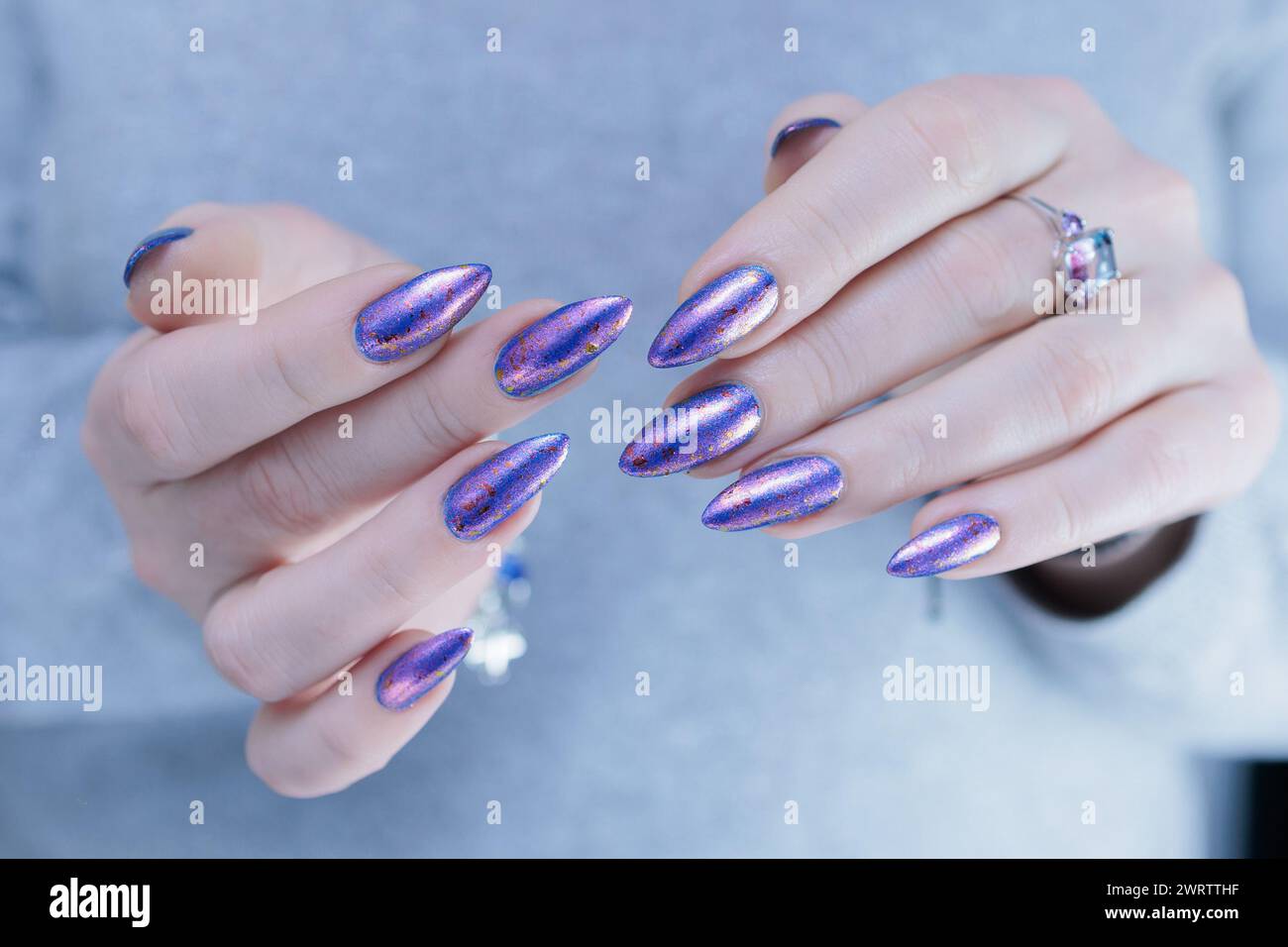 Female hand with long nails and a blue lilac color nail polish Stock ...