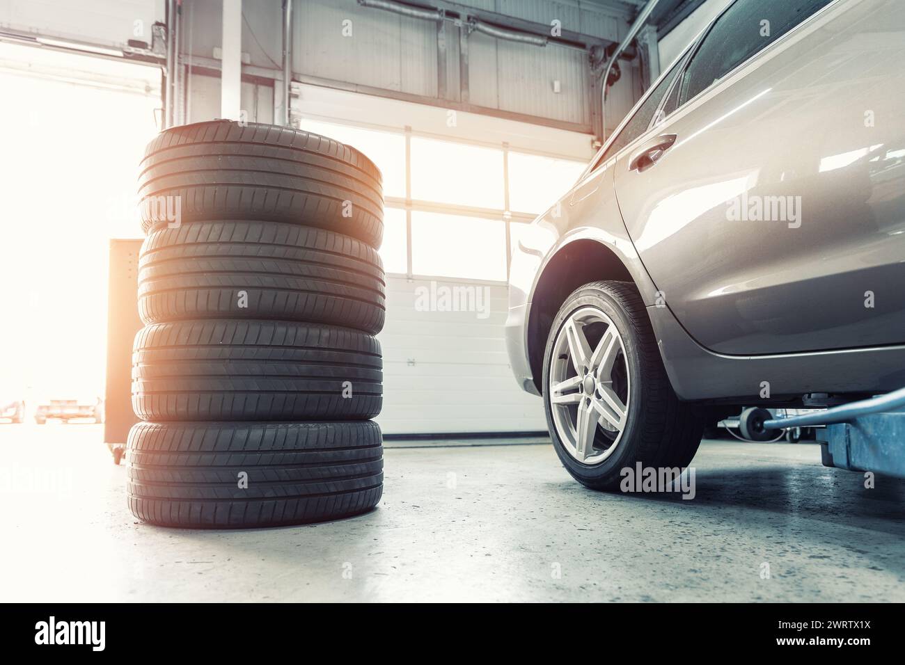 Car wheel repair with two auto lift back view. Seasonal winter tyre ...