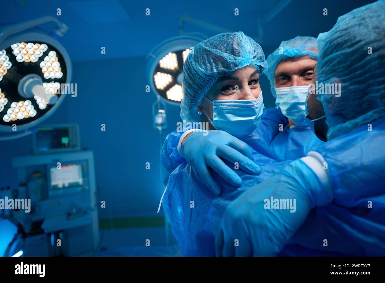 Successful surgical team hugging in surgery theater Stock Photo - Alamy