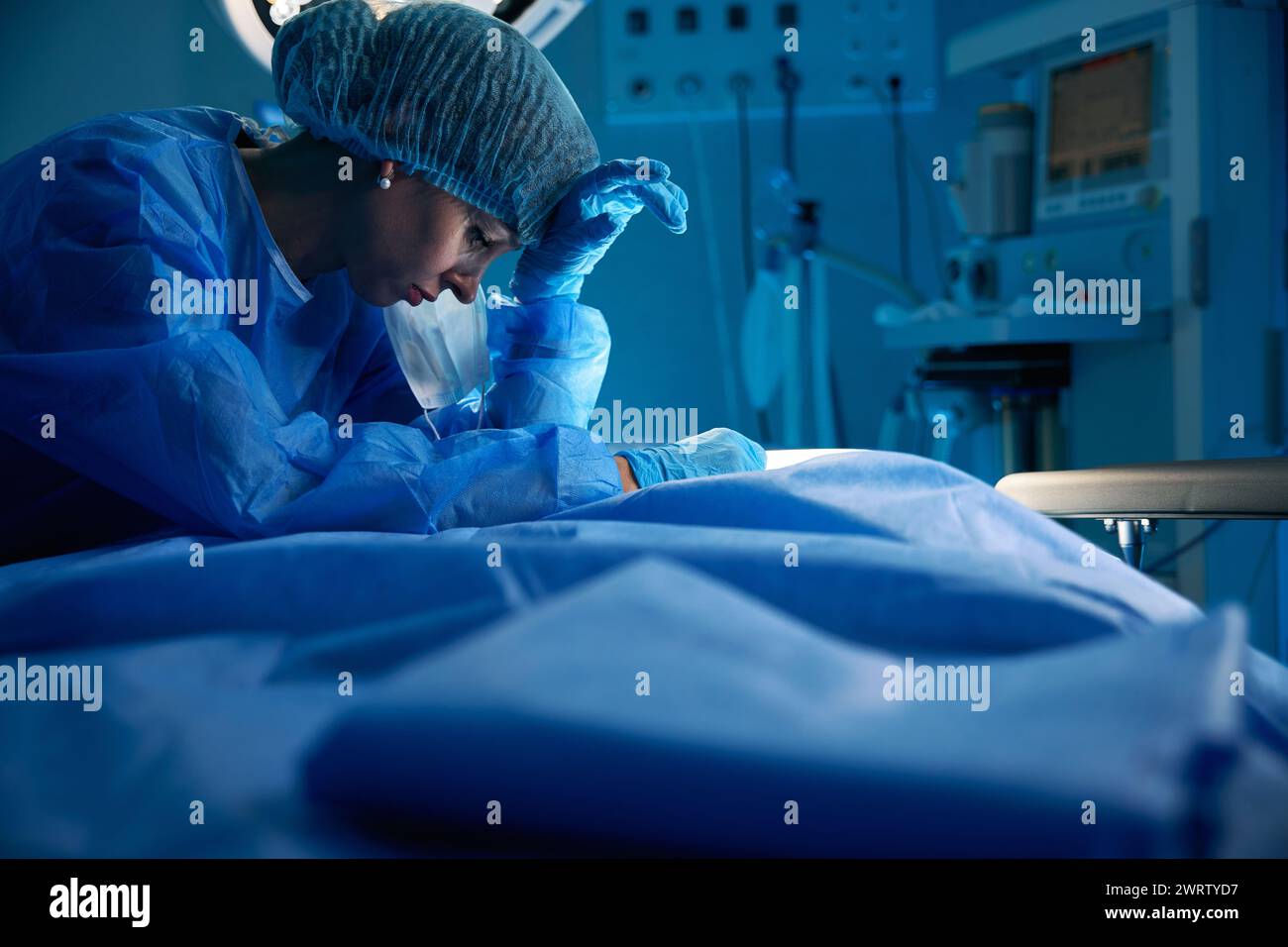 Professional tired surgeon standing in operating room after surgery ...
