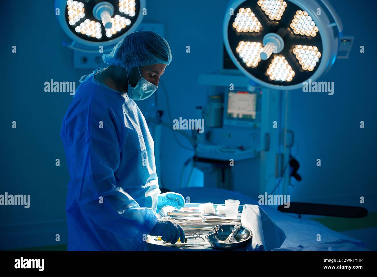 Doctor surgeon standing near table with sterile equipment preparing for ...