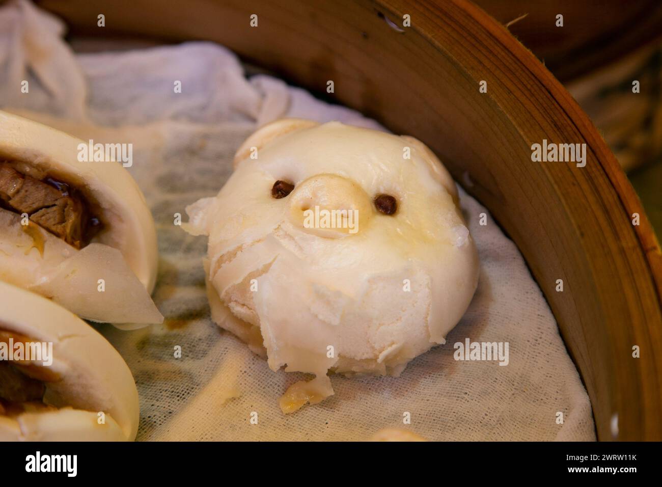Bamboo bowl with Chinese steamed, buns, Panda-man and Butachan-man ...