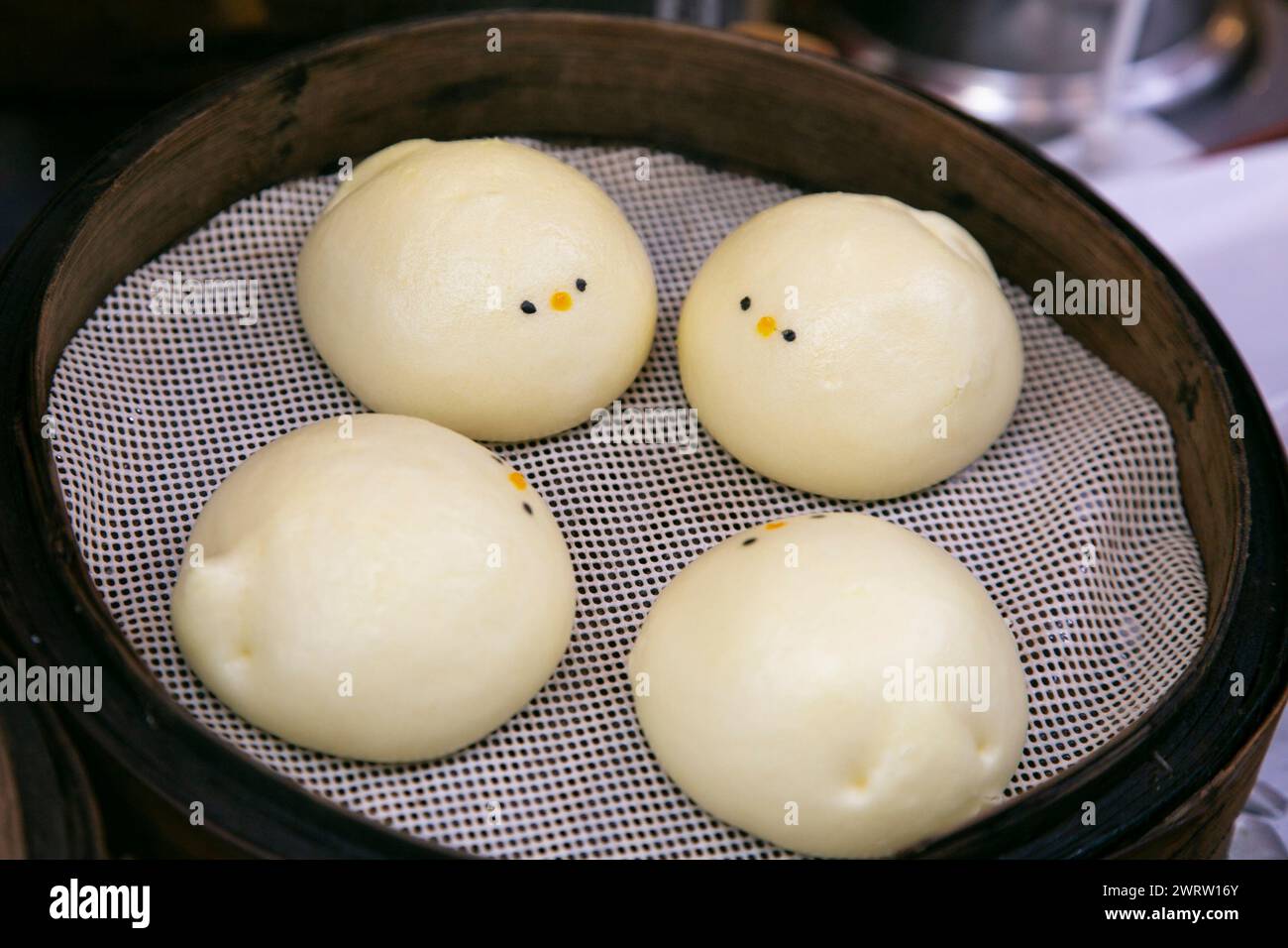Bamboo bowl with Chinese steamed, buns, Panda-man and Butachan-man ...