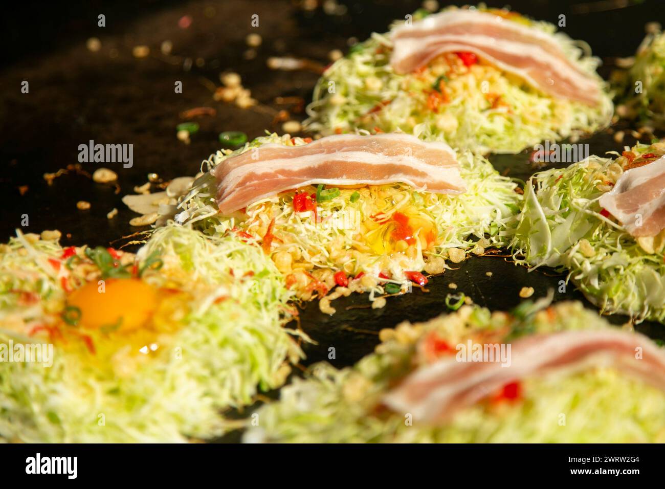 Okonomiyaki is a savory Japanese cabbage pancake “grilled as you like ...
