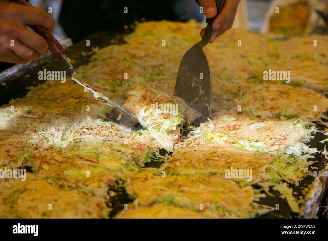 Okonomiyaki is a savory Japanese cabbage pancake “grilled as you like ...