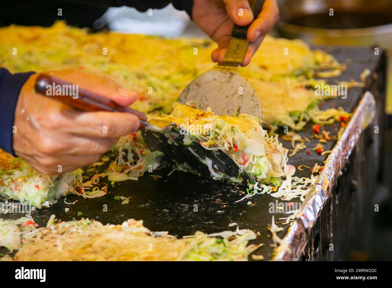 Okonomiyaki is a savory Japanese cabbage pancake “grilled as you like ...