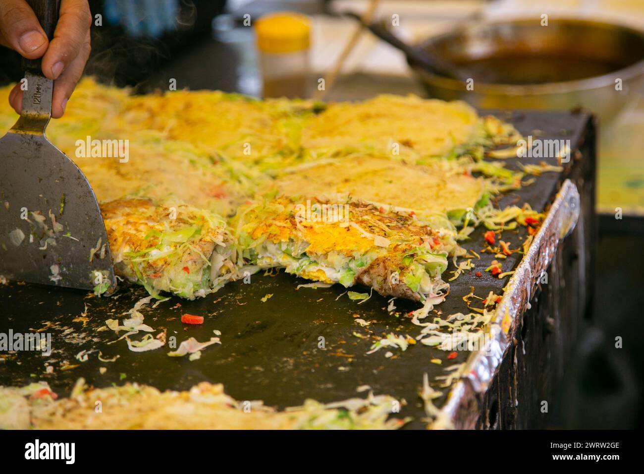 Okonomiyaki is a savory Japanese cabbage pancake “grilled as you like ...