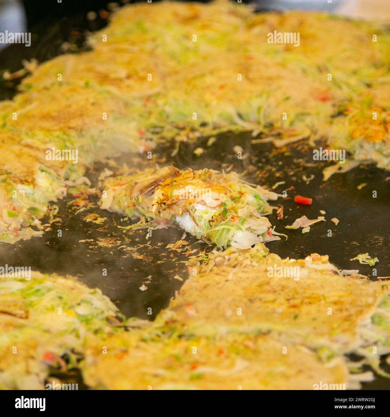 Okonomiyaki is a savory Japanese cabbage pancake “grilled as you like ...
