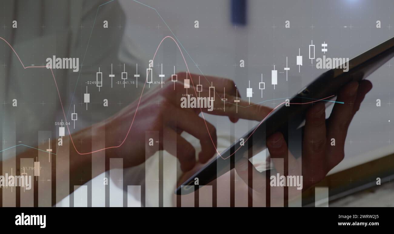 Digital composite of a man using a digital tablet while graphs move in ...