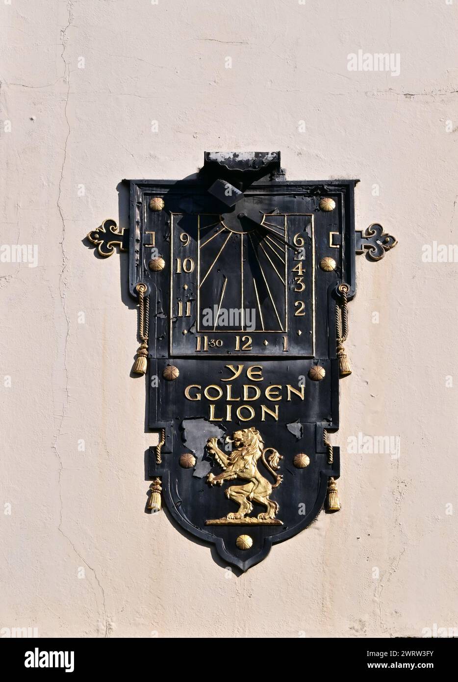 Sundial and 'Ye Golden Lion' pub sign on the wall in Dean Street, Soho ...