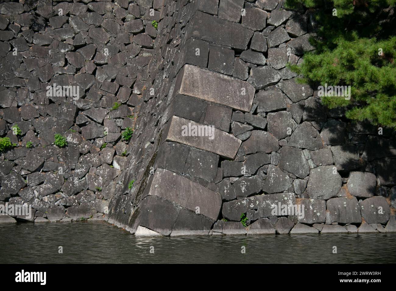 In the Japanese Imperial Palace in Tokyo, Japan, massive stone walls ...