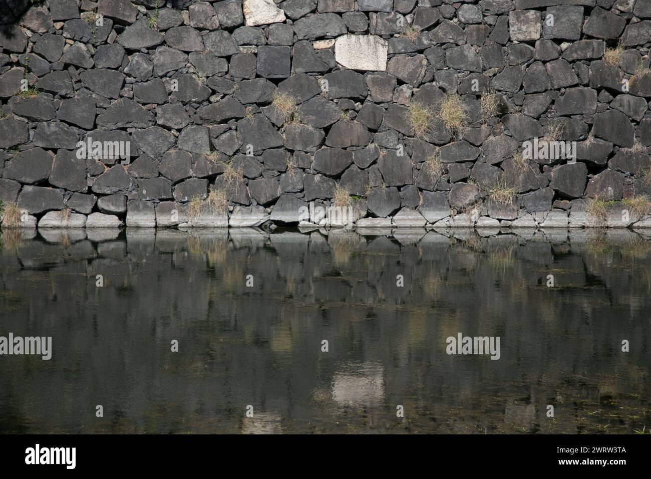 In the Japanese Imperial Palace in Tokyo, Japan, massive stone walls ...