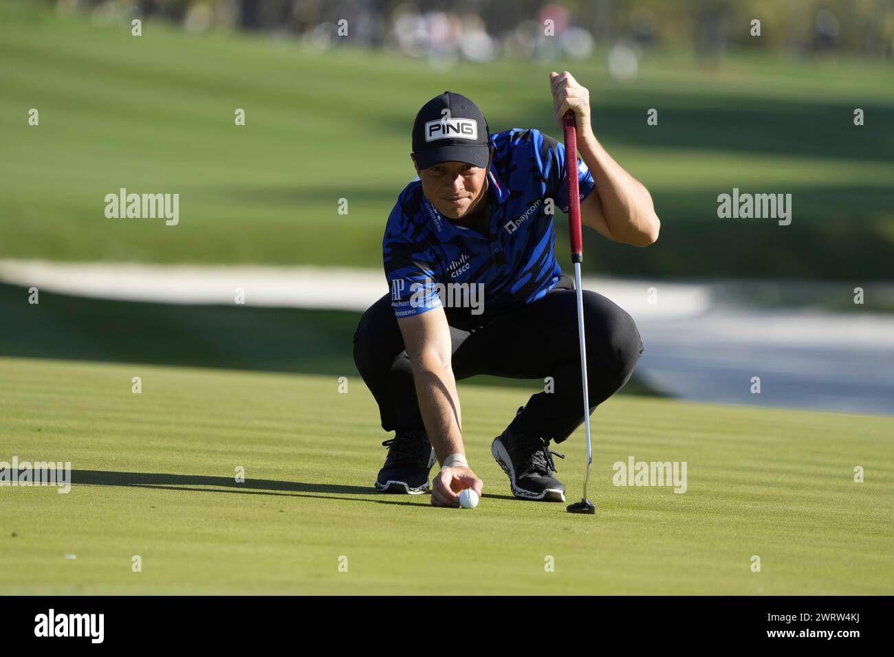 Viktor Hovland, of Norway, lines up a putt on the 14th hole during the ...