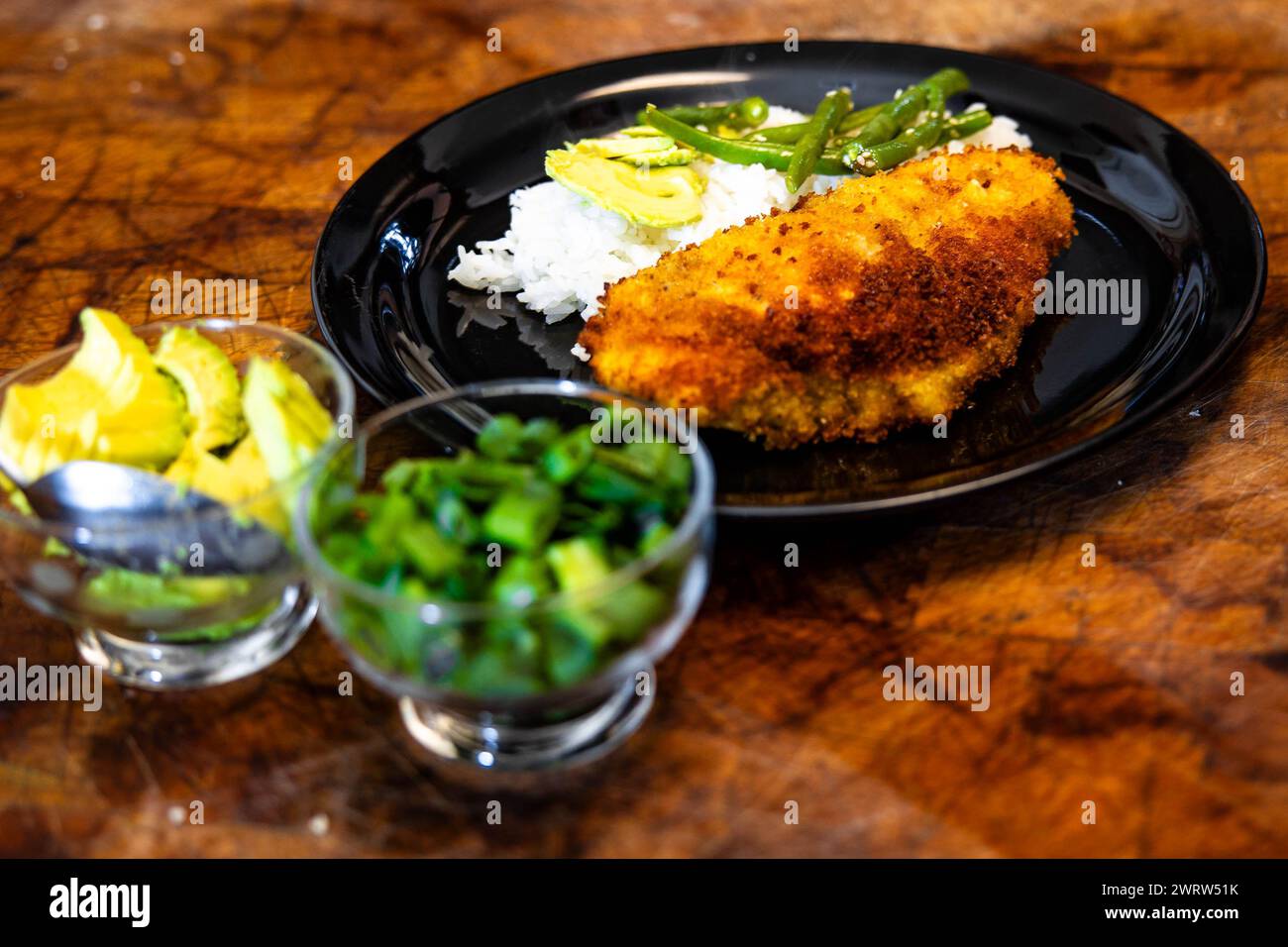 Plate with chicken cutlets, rice, and fruit on a white background Stock ...