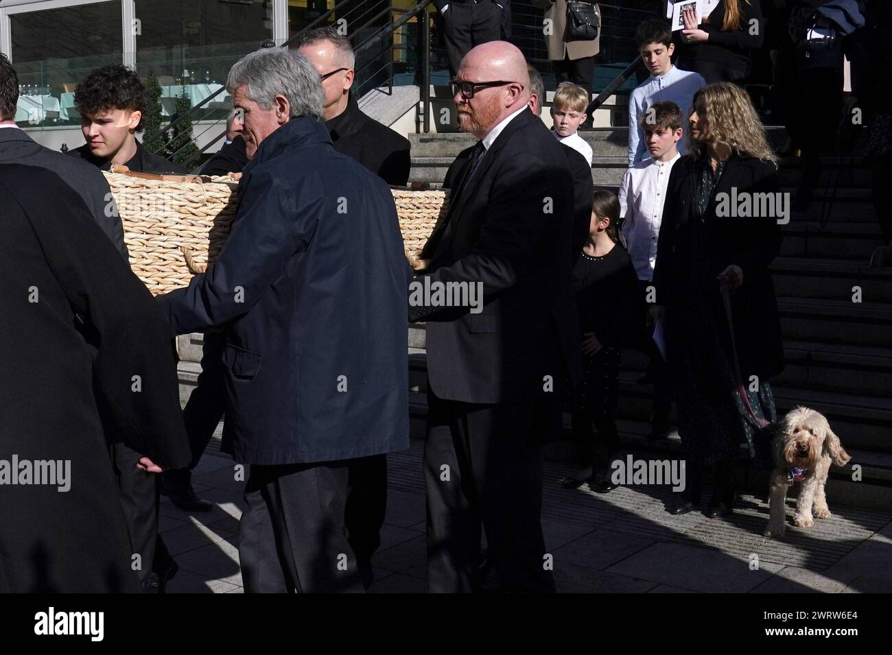 Charlie Bird's wife Claire with his dog Tiger as his coffin is carried ...